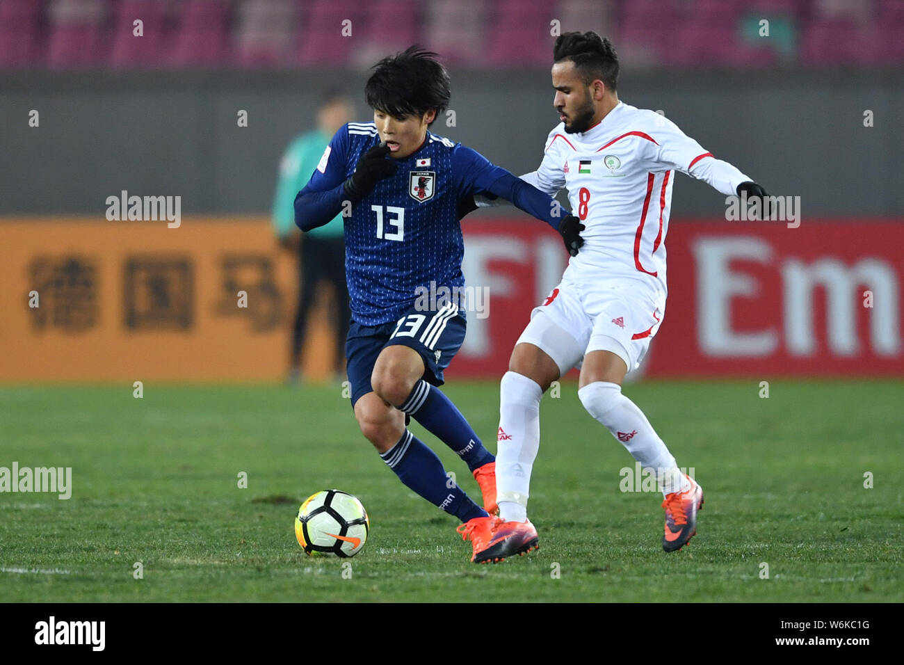 Yuto Iwasaki of Japan, left, challenges Omar Sandouqa of Palestine in their Group B match during ...