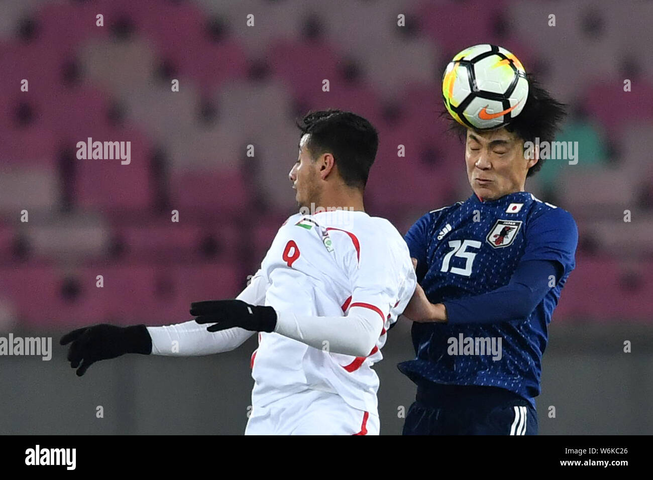 Honoya Syouji of Japan, right, heads the ball against a player of Palestine in their Group B ...