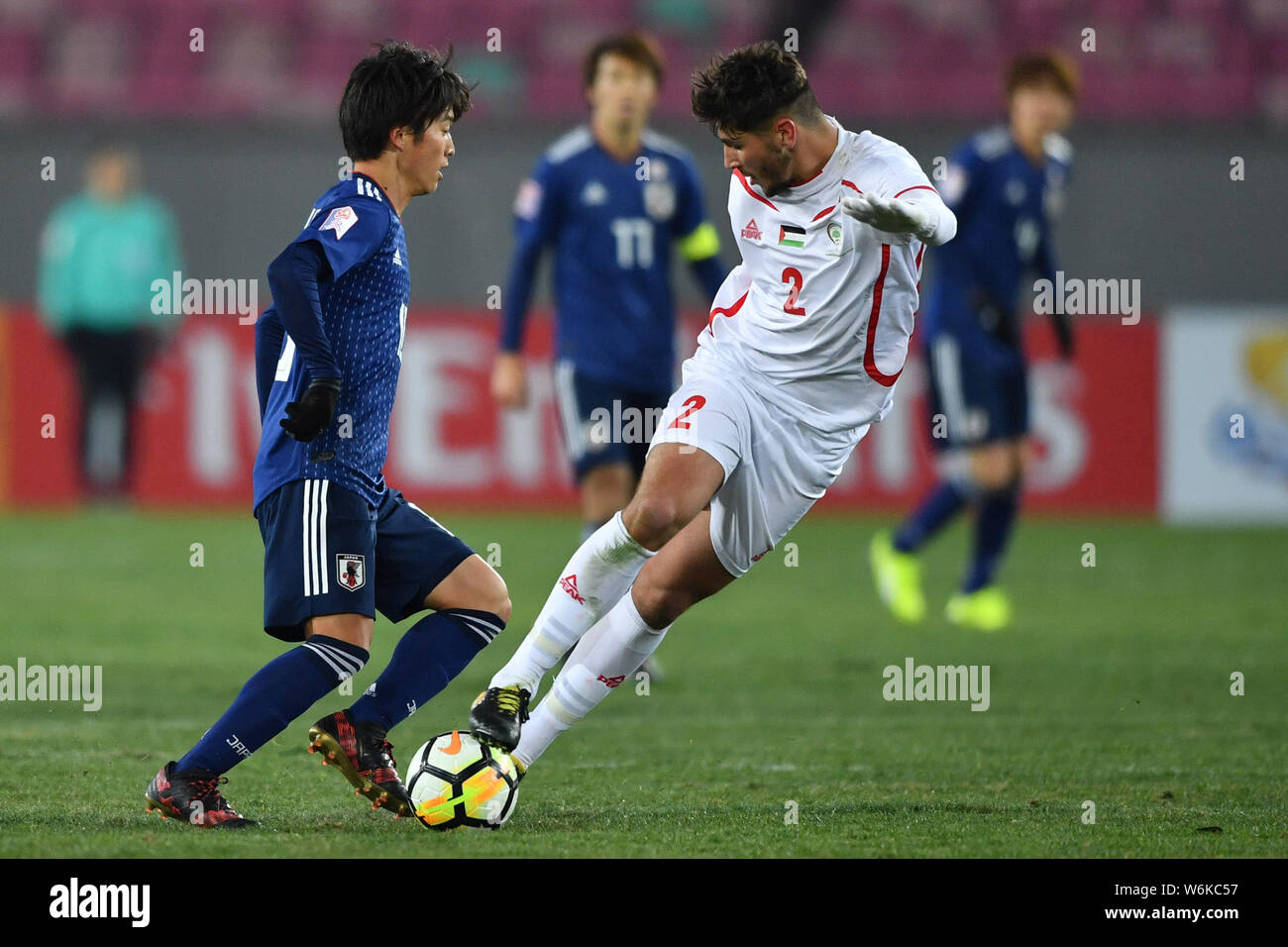 A player of Japan, left, challenges Michelmilad Termanini of Palestine ...