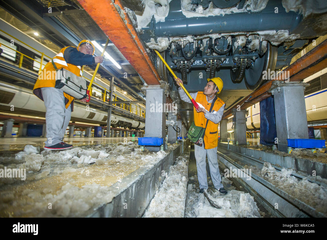 Chinese mechanicians clear snow off the CRH (China Railway High-speed ...