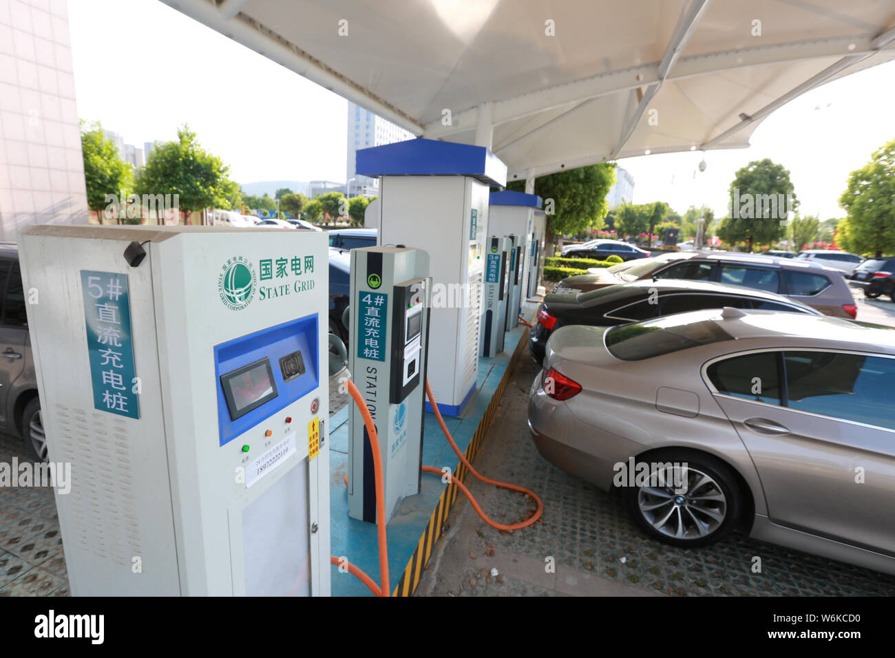 --FILE--Electric vehicles (EVs) are being recharged at a charging ...