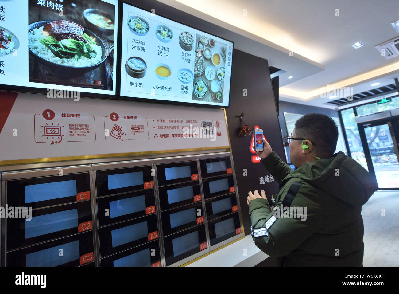 A consumers is scanning a QR code to open the cupboard at the first ...