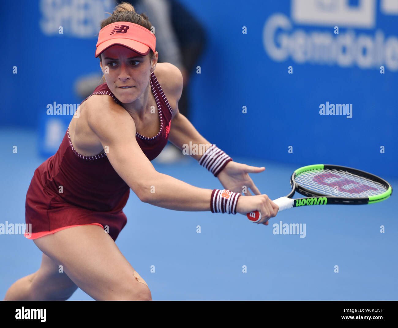 Nicole Gibbs of the United States returns a shot to Simona Halep of ...