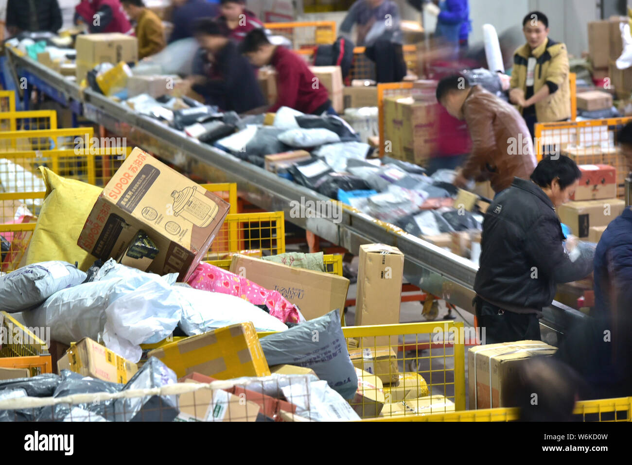 --FILE--Chinese workers sort out piles of parcels, most of which are from Singles Day online ...