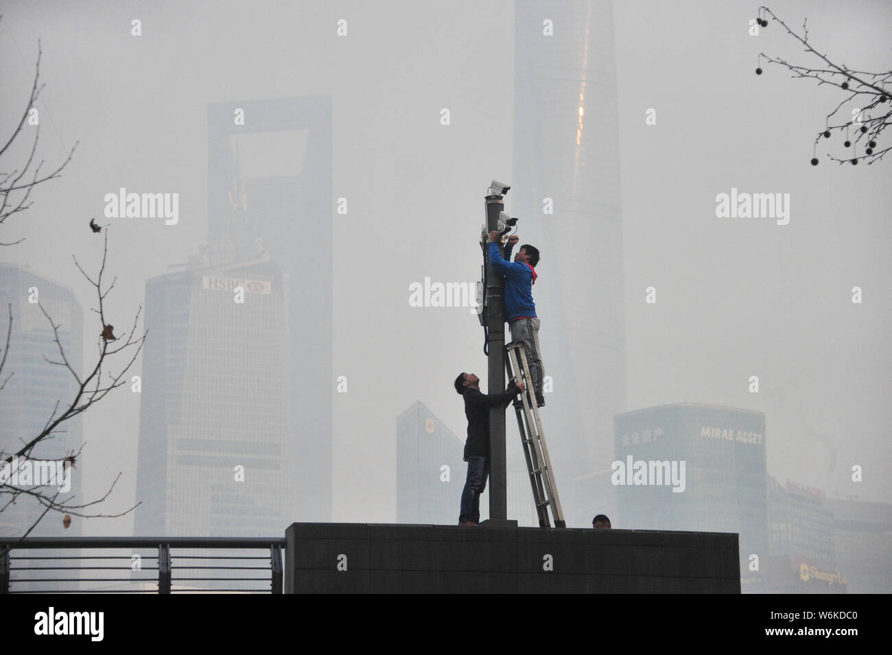 Chinese workers check surveillance cameras on the Bund as the Shanghai ...