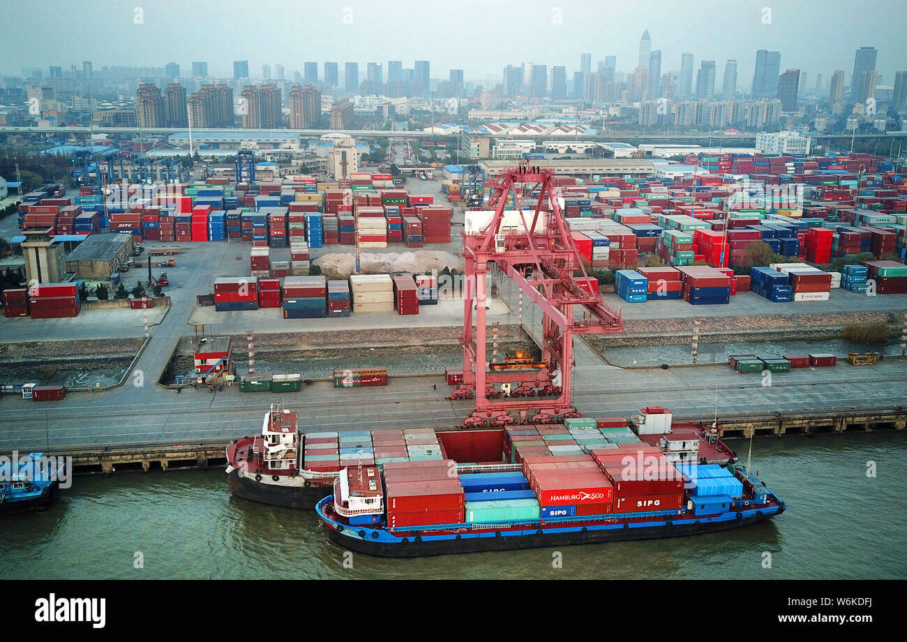Cargo ships loaded with containers to be shipped abroad berth on a quay ...