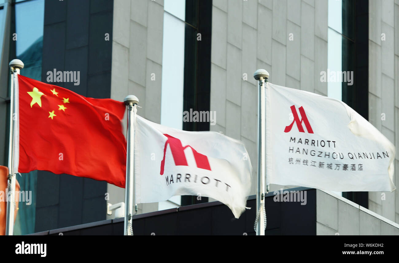 --FILE--A Chinese national flag and Marriott flags flutter in front of ...