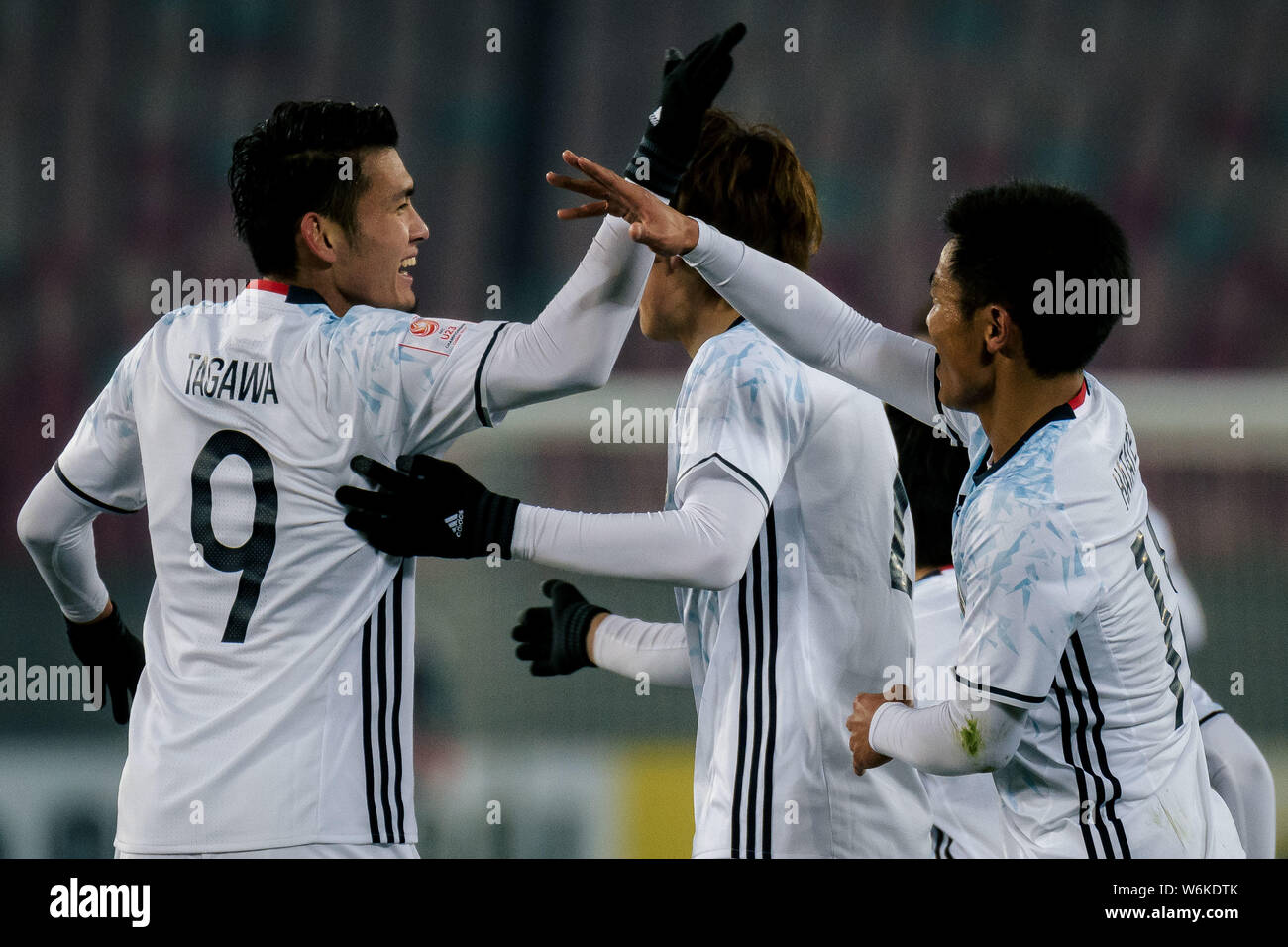 Players of Japan celebrate after scoring against Thailand in their Group B match during the 2018 ...