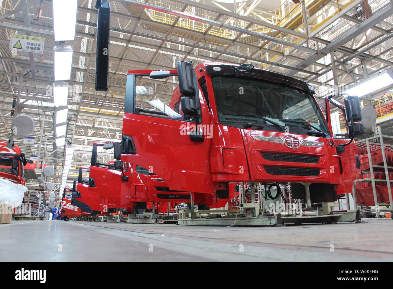 --FILE--A Chinese worker assembles trucks on the assembly line at an ...