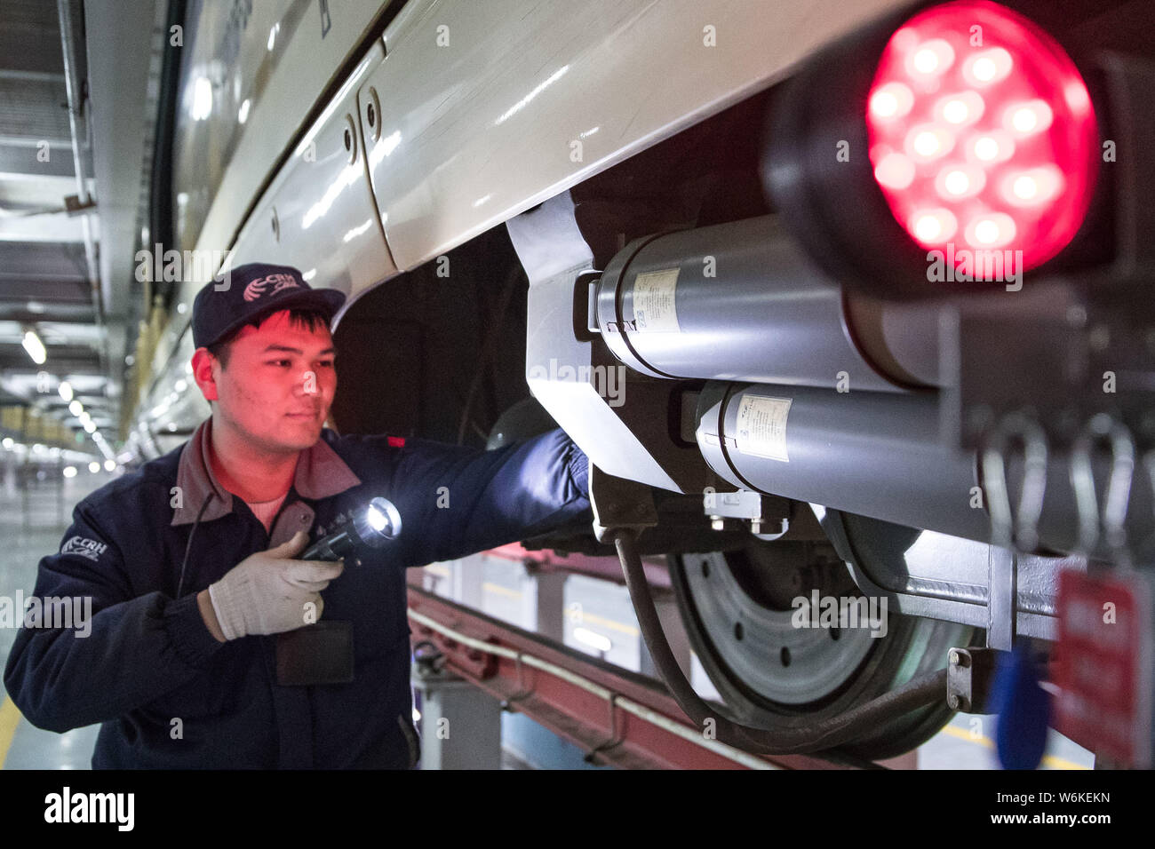 A Chinese worker checks a CRH (China Railway High-speed) bullet train ...
