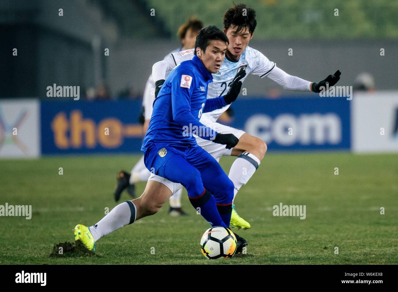 Yugo Tatsuta, right, of Japan challenges a player of Thailand in their Group B match during the ...