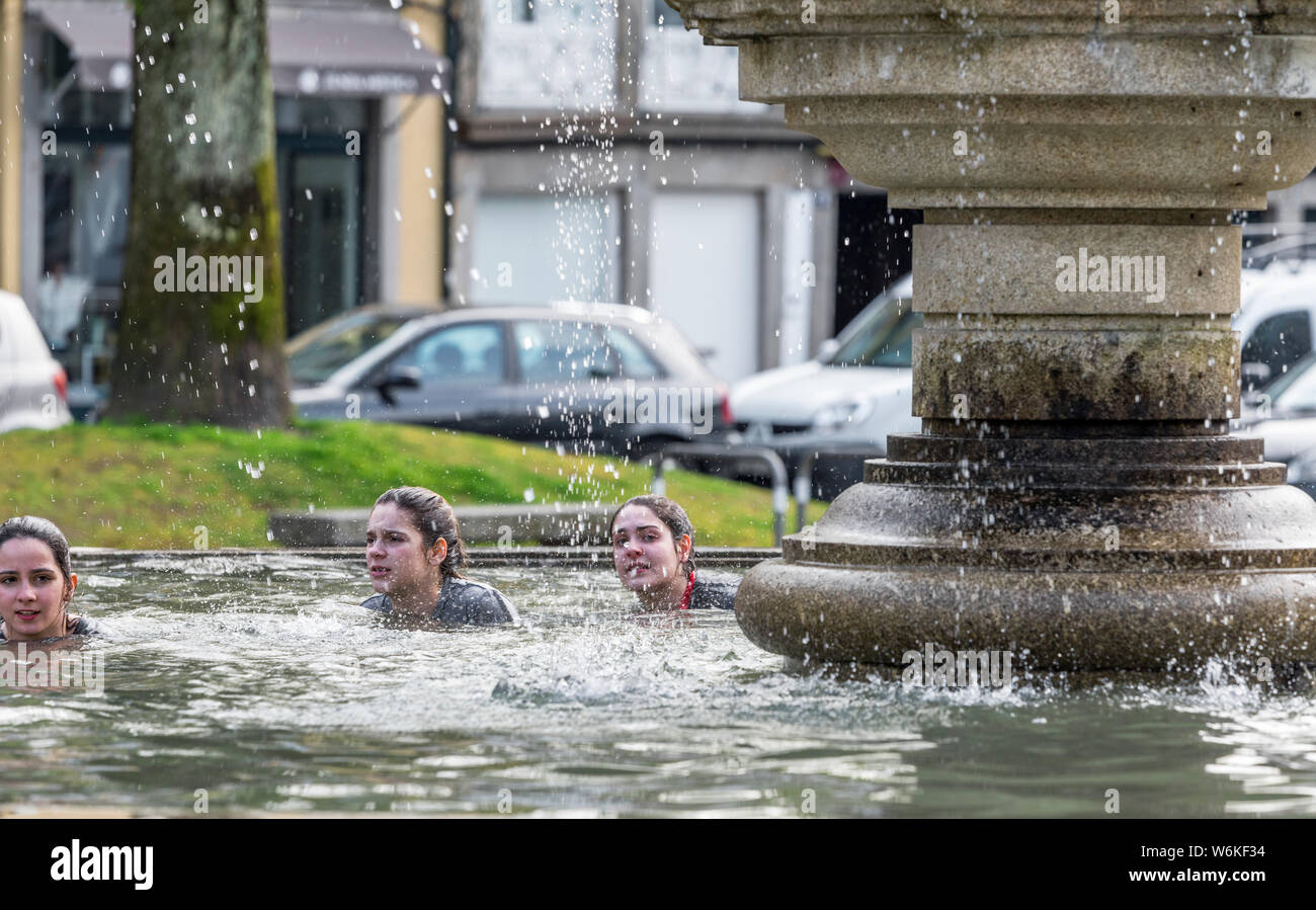 Girls students having fun in the city fountain. Braga, Portugal Stock ...