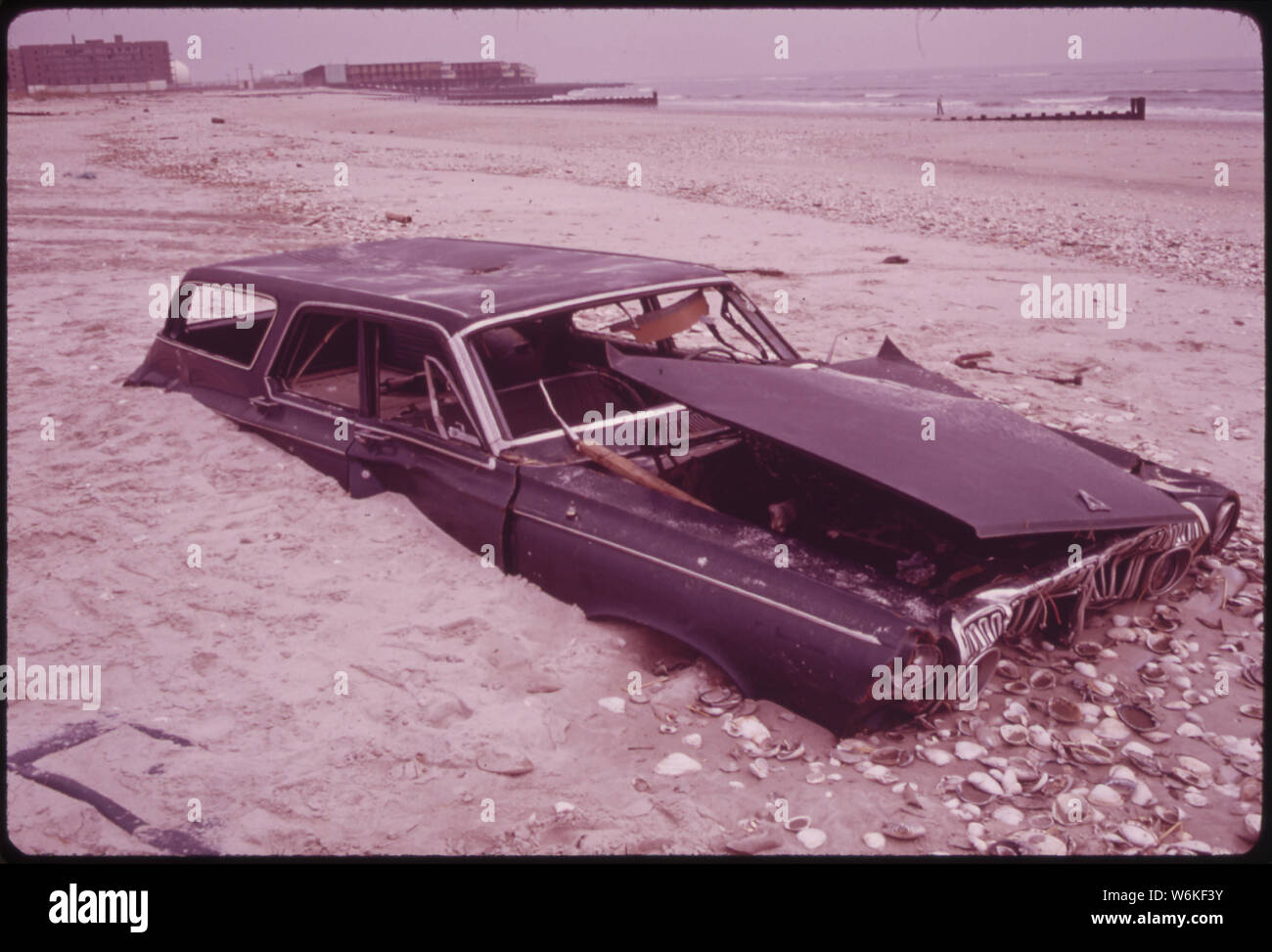 SAND COVERS ABANDONED CAR ON BEACH AT BREEZY POINT SOUTH OF JAMAICA BAY ...