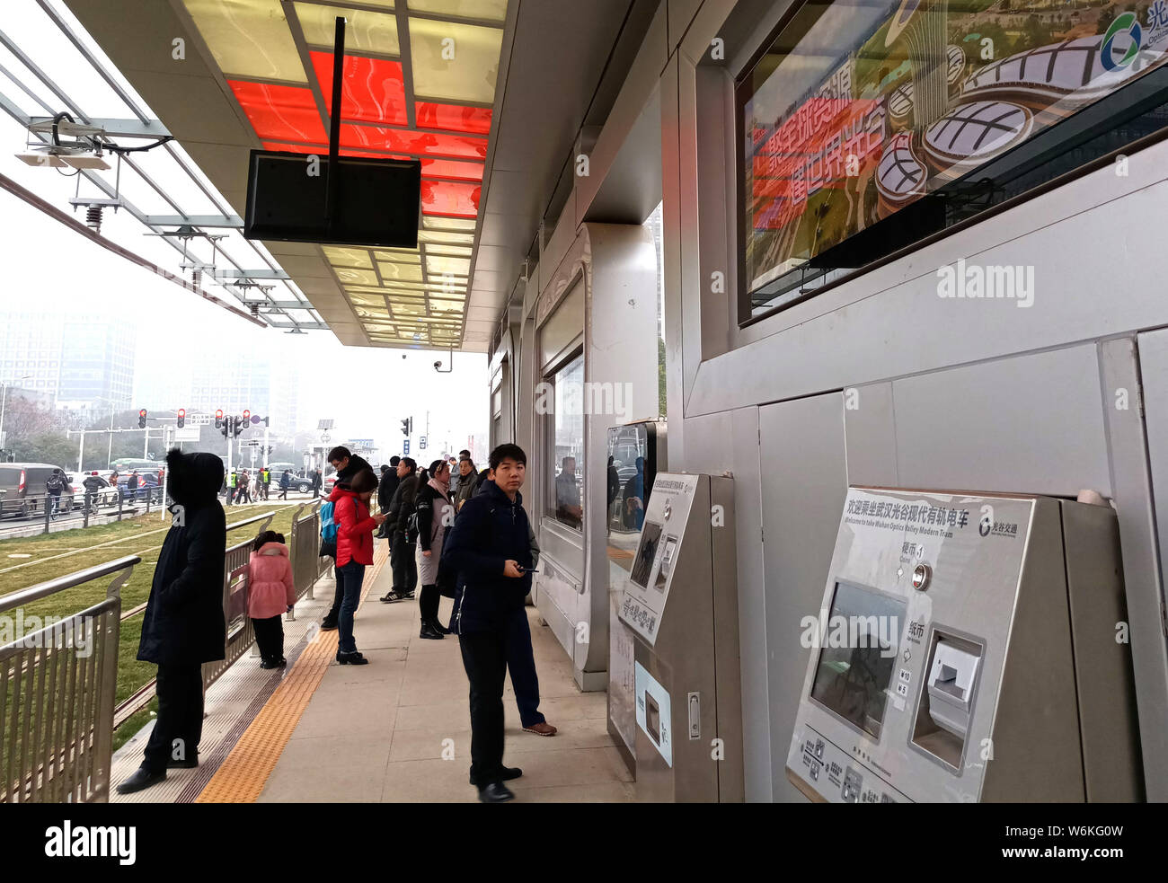 Passengers wait for an "Optics Valley Quantum" tram during the trial ...