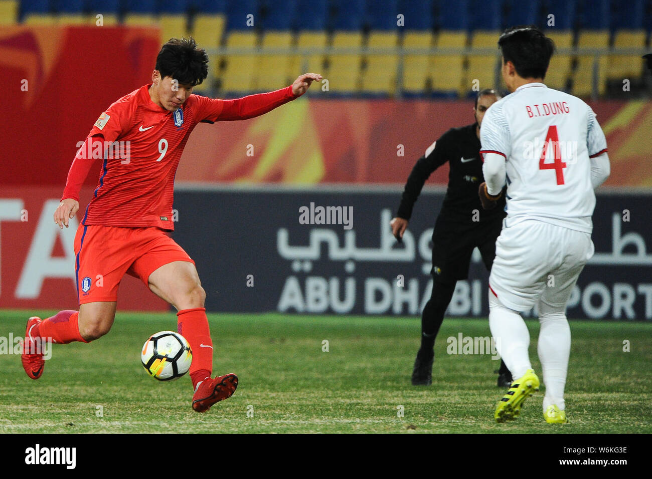 Lee Keun Ho, left, of South Korea kicks the ball to make a pass against Bui Tien Dung of Vietnam ...