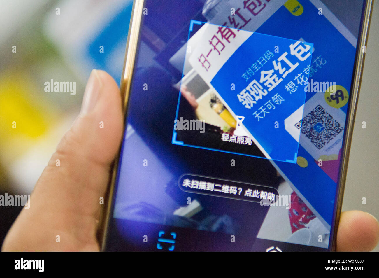 --FILE--A Chinese mobile phone user uses his smartphone to scan a QR code via Alipay, the mobile ...