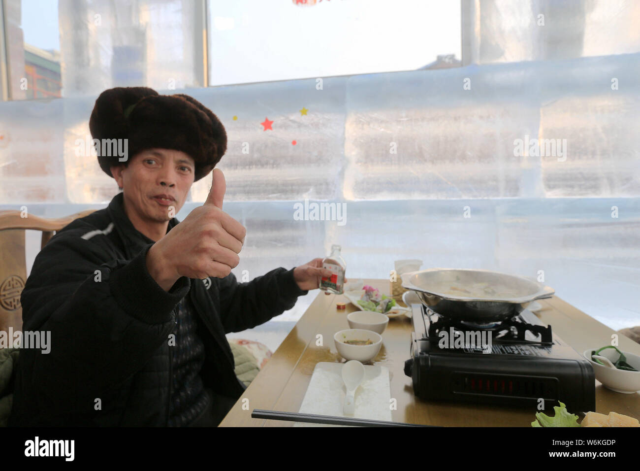 A Chinese customer enjoys hot pot at a hotpot restaurant made of ice ...