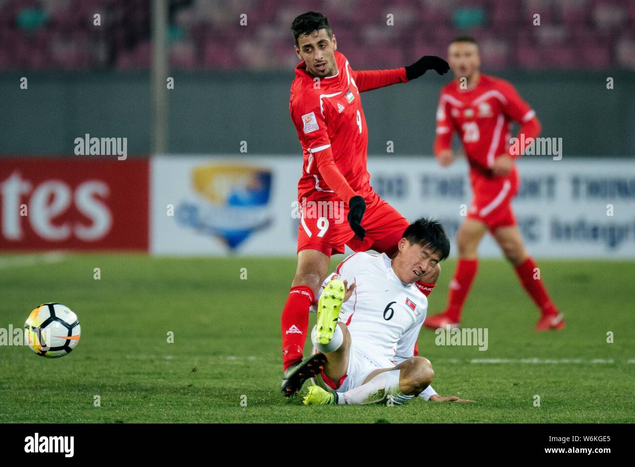 Oday Ibrahim Mohammad Dabbagh of Palestine, top, kicks the ball to make ...