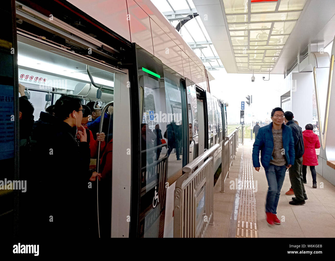 Passengers are seen in an "Optics Valley Quantum" tram during the trial ...