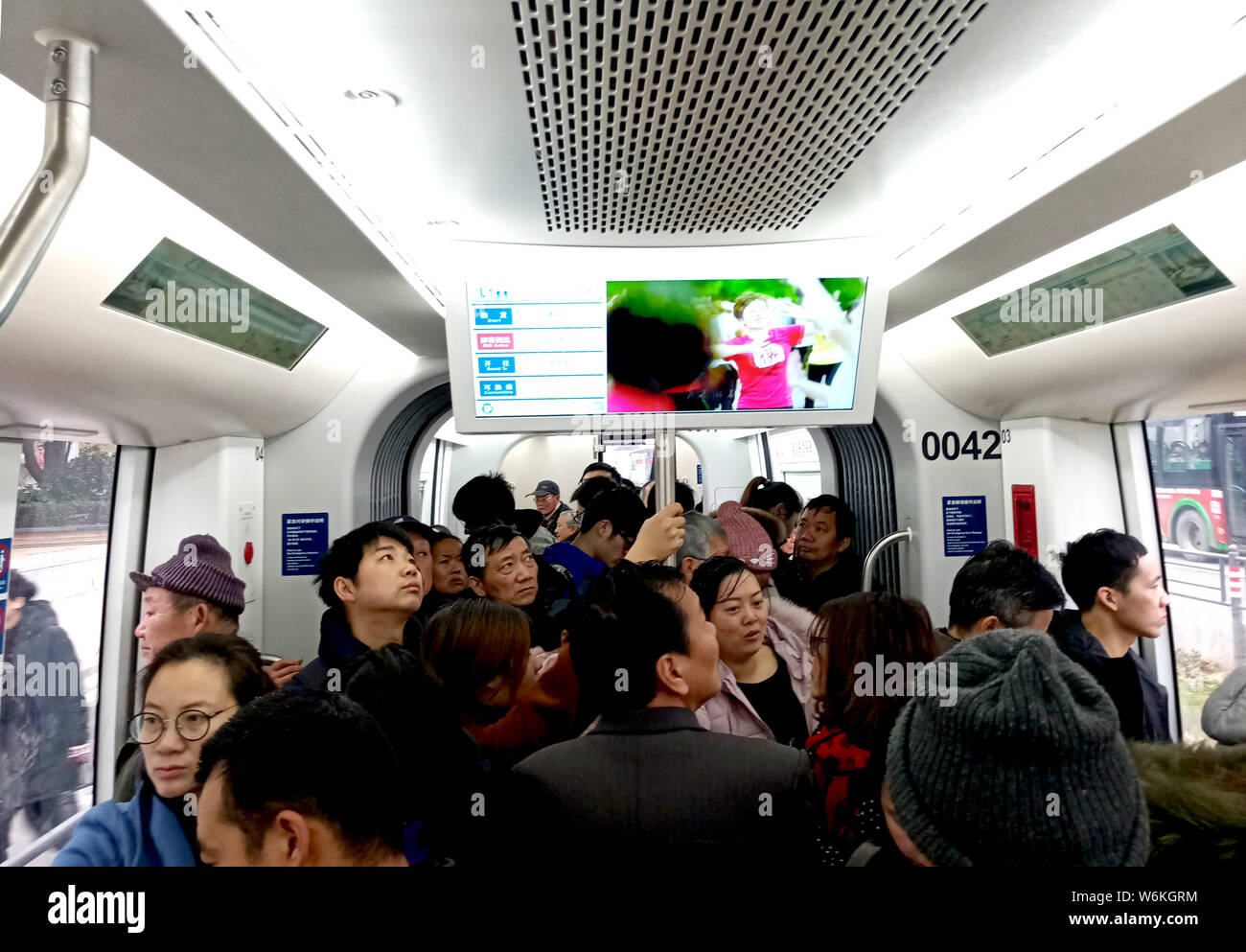 Passengers crowd to an "Optics Valley Quantum" tram during the trial ...