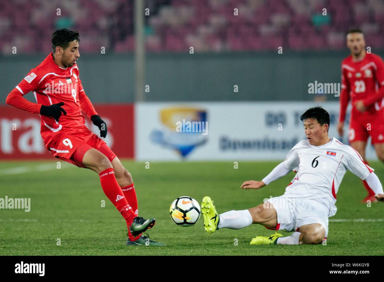 Oday Ibrahim Mohammad Dabbagh of Palestine, left, kicks the ball to ...