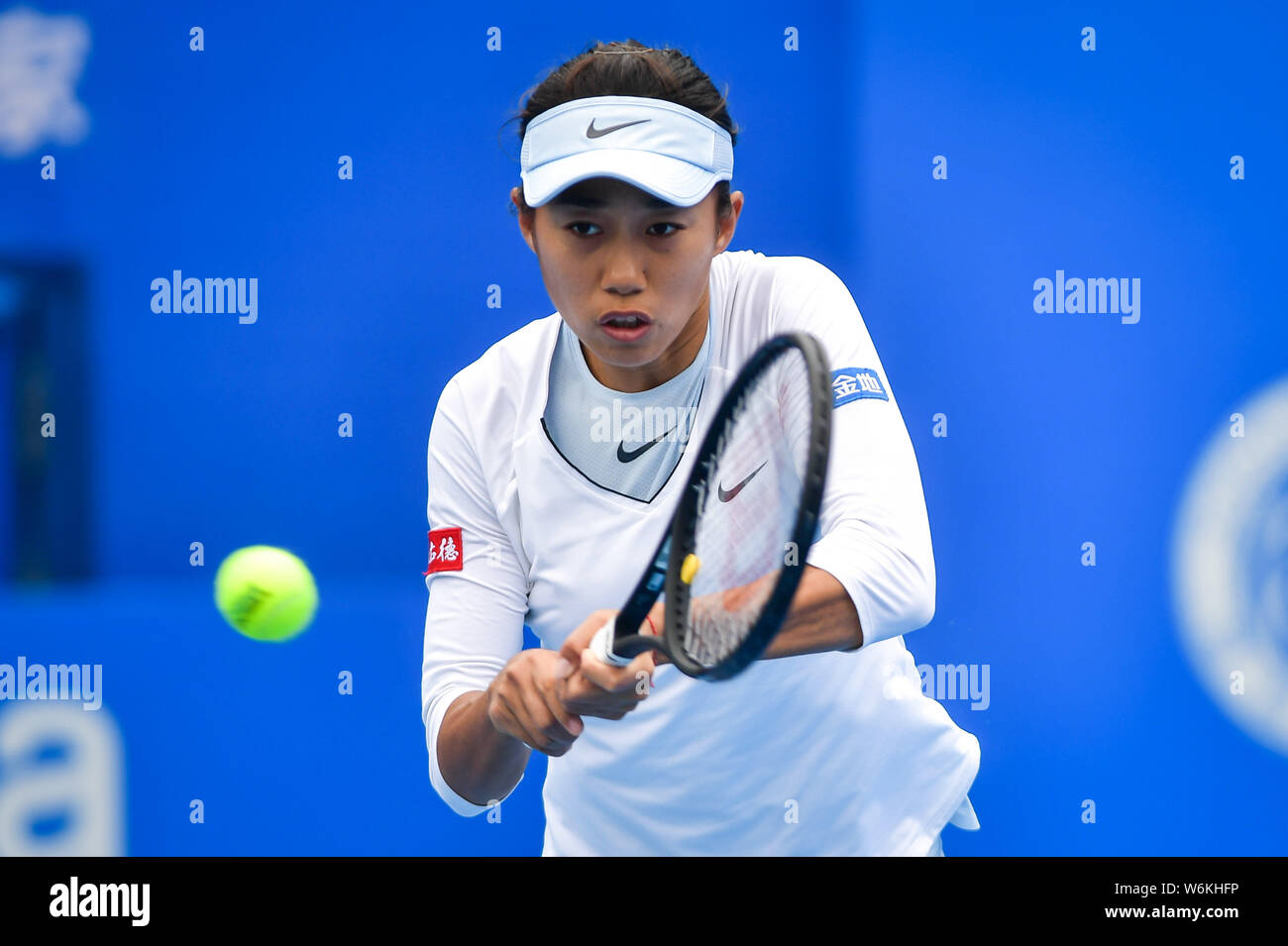 Zhang Shuai of China returns a shot to Anna Blinkova of Russia in their ...