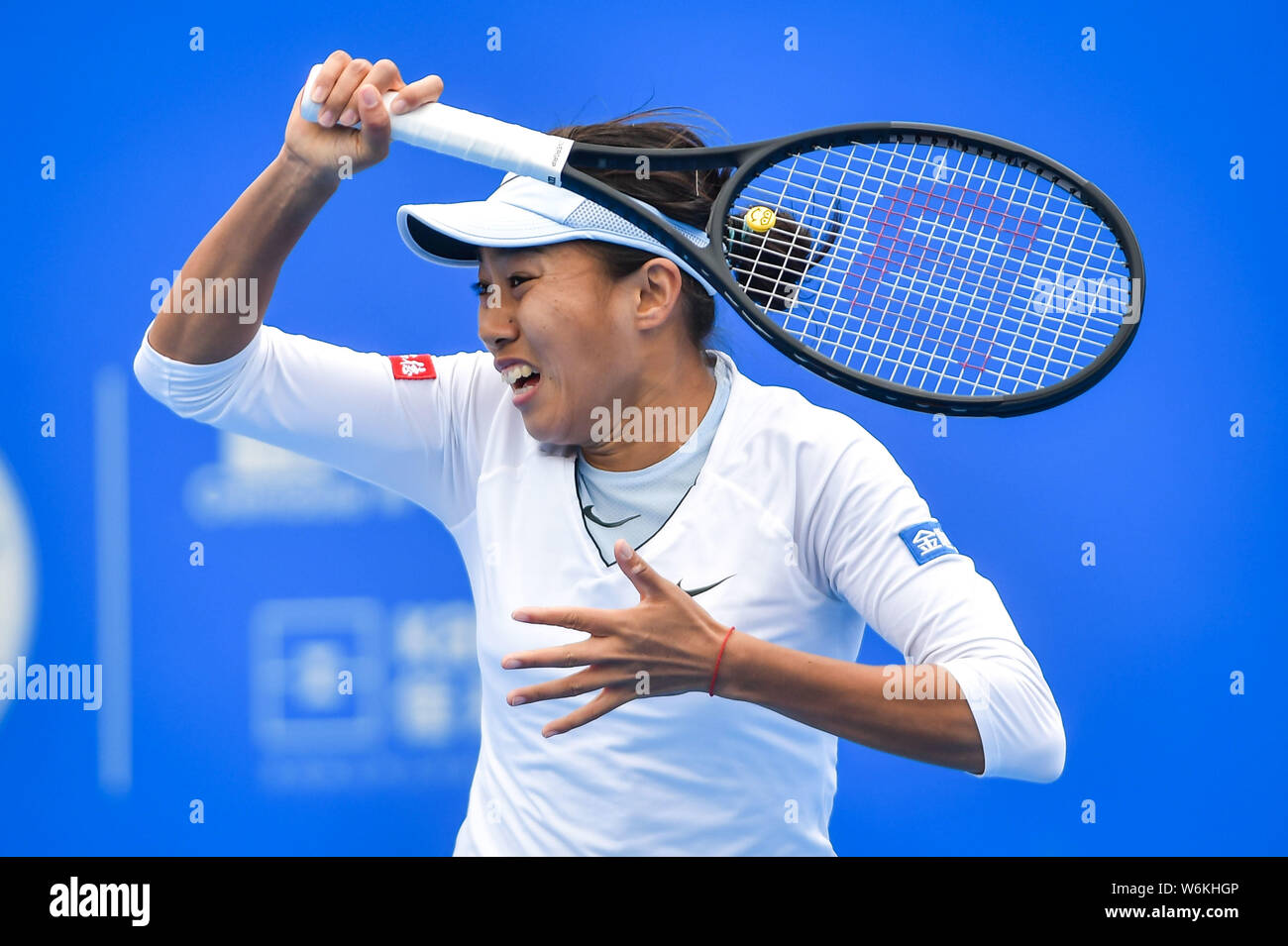 Zhang Shuai of China returns a shot to Anna Blinkova of Russia in their ...