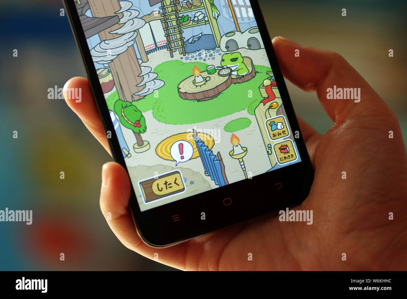 --FILE--A Chinese player "raises" a frog as she plays mobile game "Tabi ...
