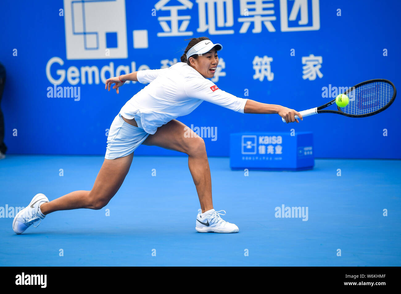 Zhang Shuai of China returns a shot to Anna Blinkova of Russia in their ...