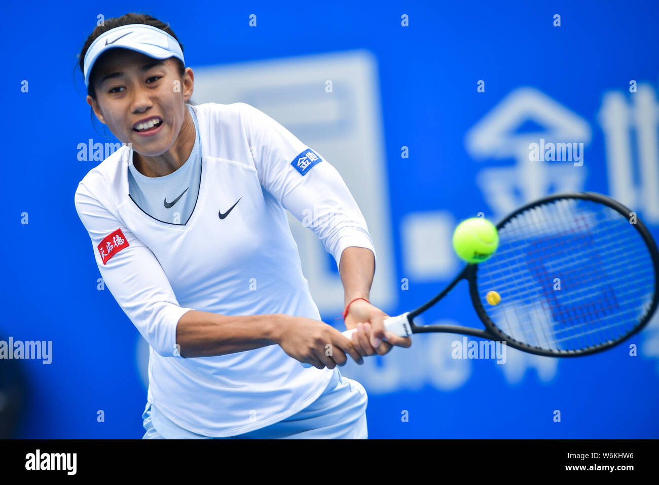 Zhang Shuai of China returns a shot to Anna Blinkova of Russia in their ...