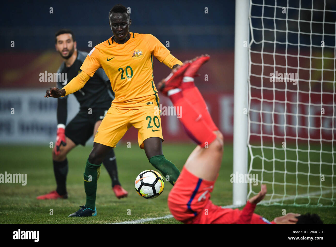 Thomas Deng of Australia kicks the ball to make a pass against South ...