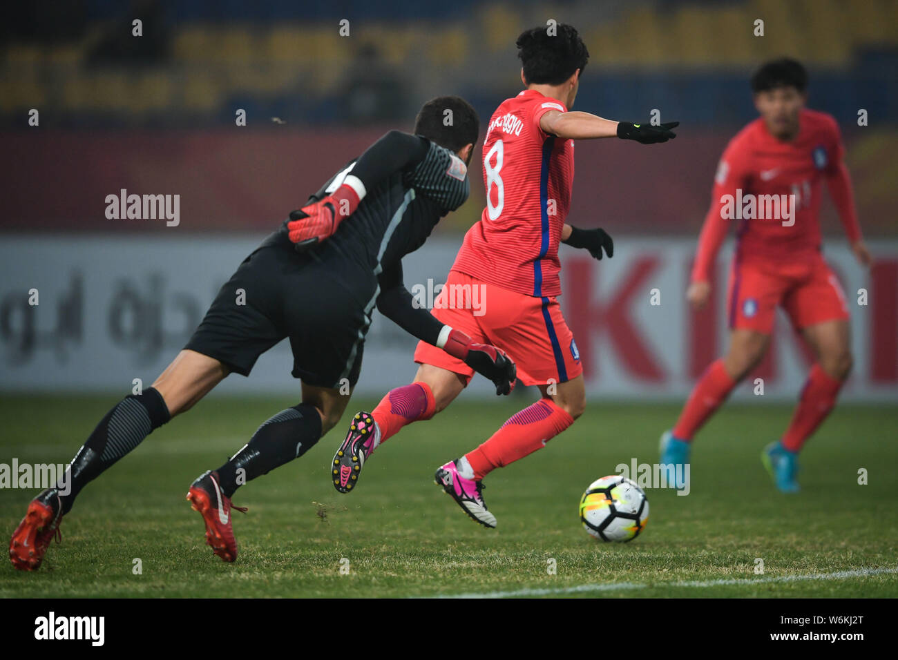 Han Seung-Gyu, right, of South Korea kicks the ball to make a pass ...