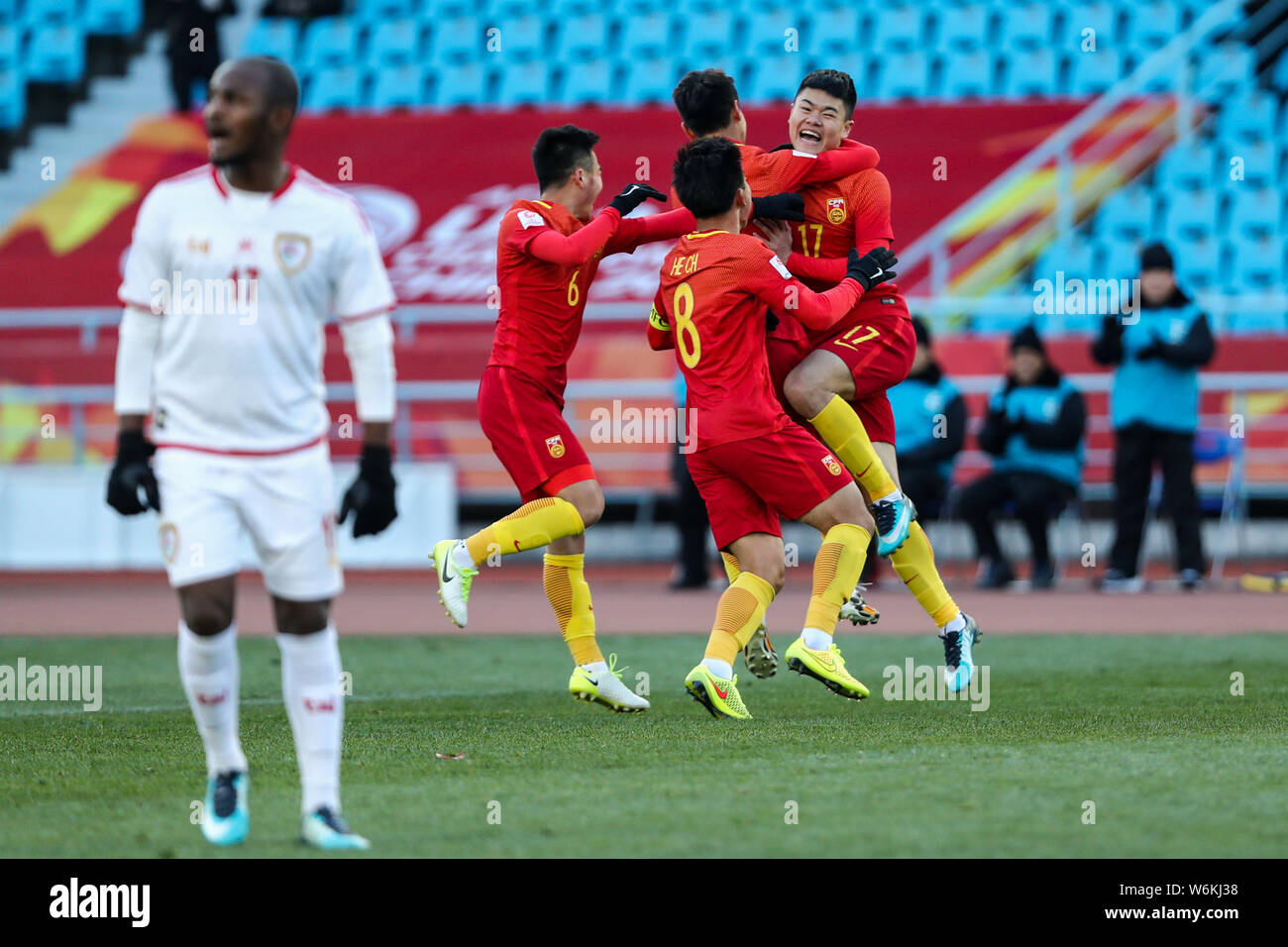 Players of China celebrate after scoring against Oman in the Group A match between China and ...