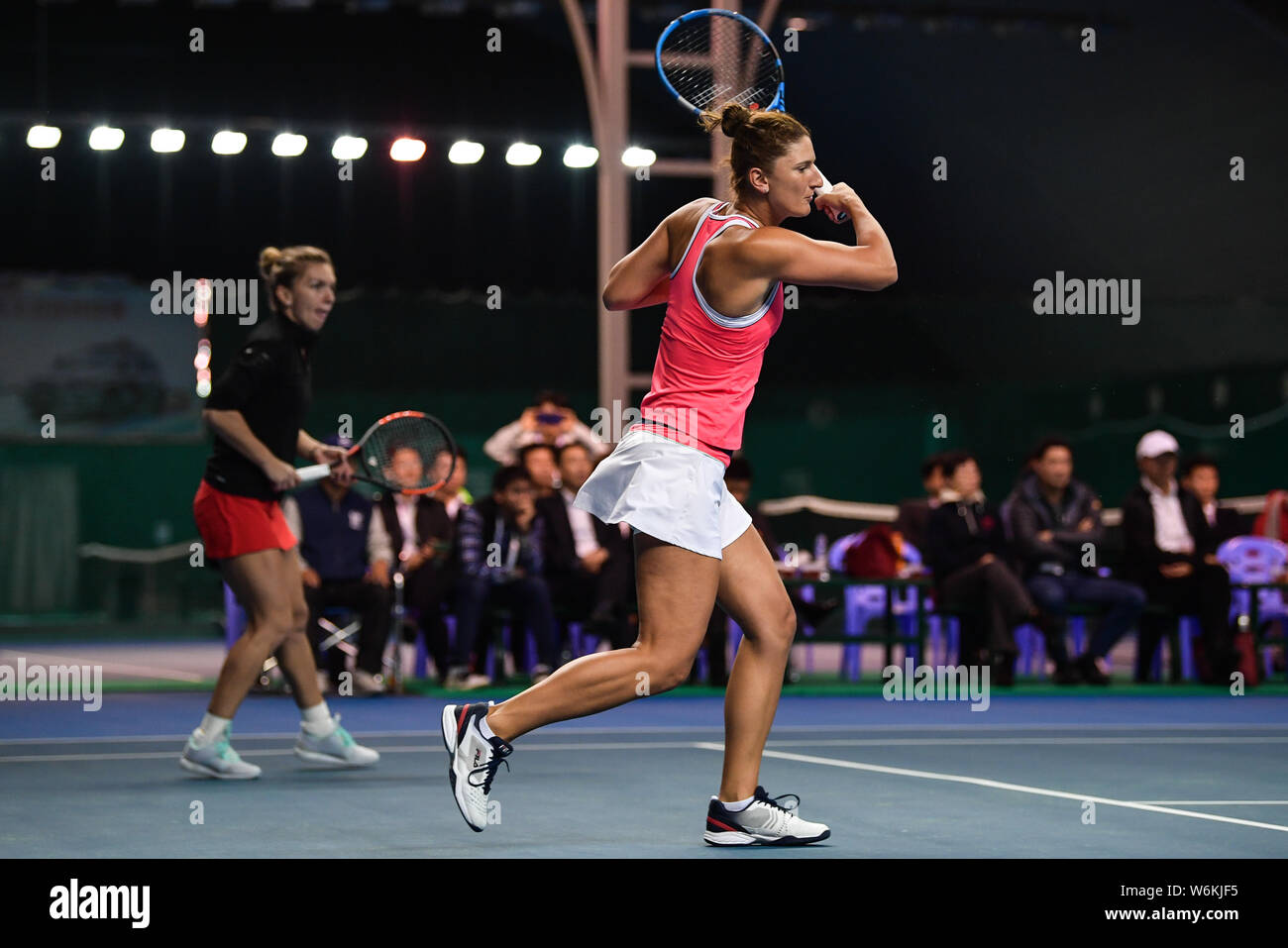 Irina-Camelia Begu of Romania, front, returns a shot as she and her ...
