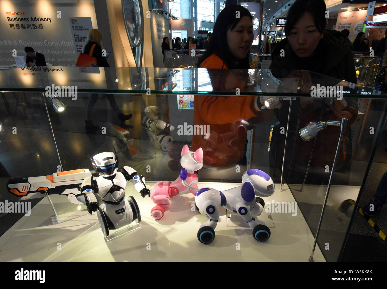 Visitors look at robots on display during the HKTDC Hong Kong Toys ...