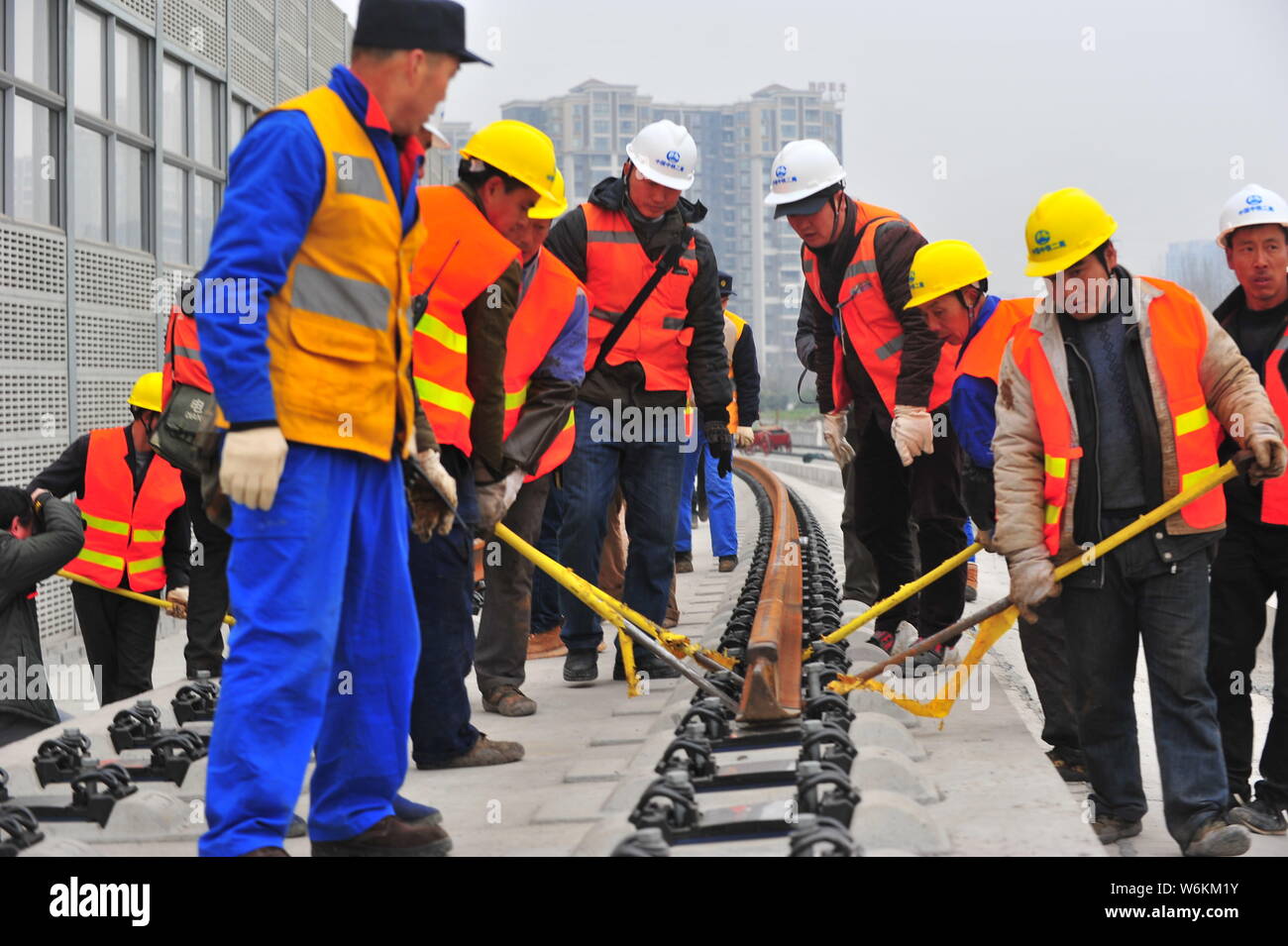 Chinese workers pave the first 500-meter-long rail on the Chengdu West ...