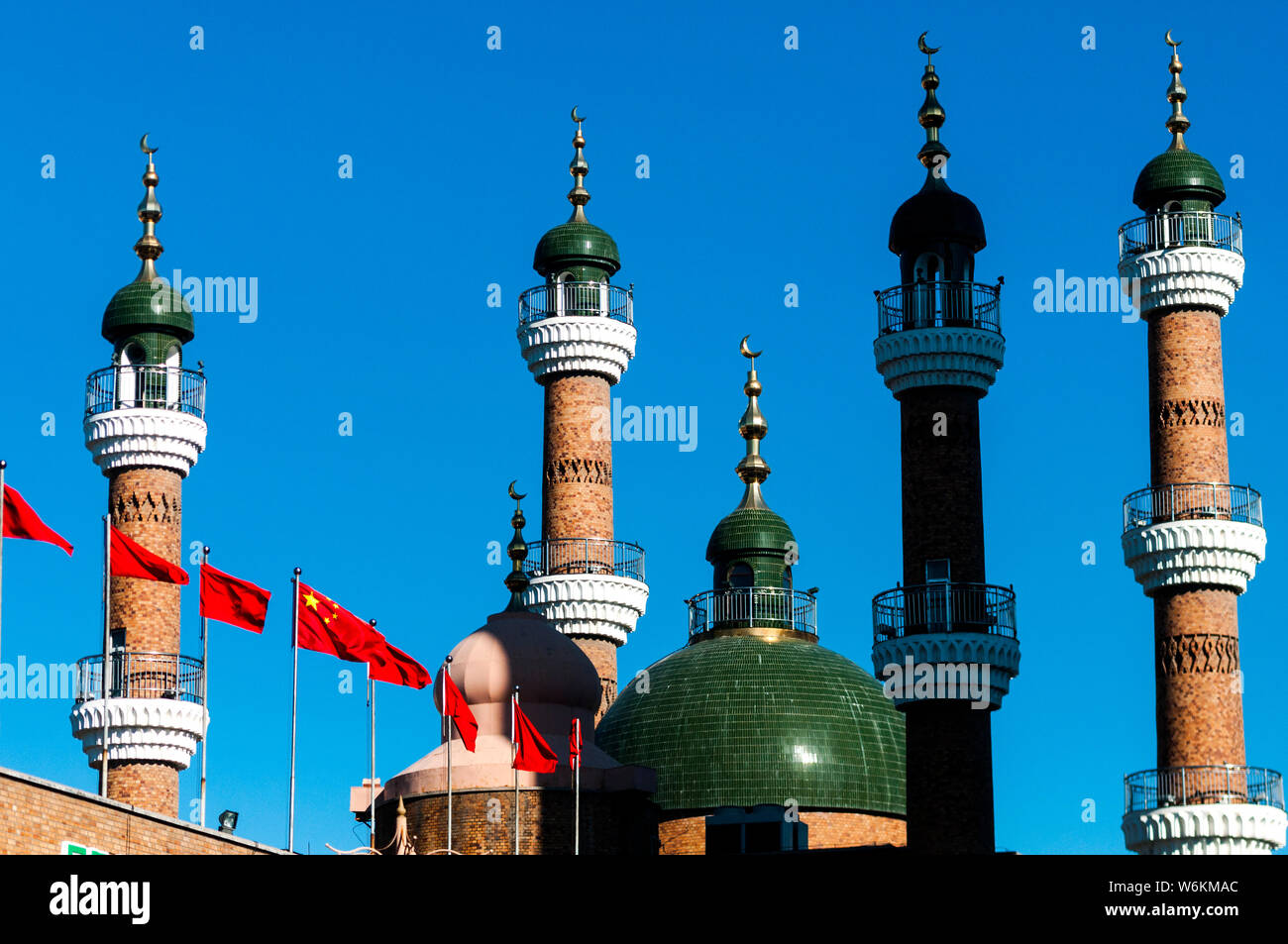 Chinese national flags flutter on the rooftop of an islamic building at ...