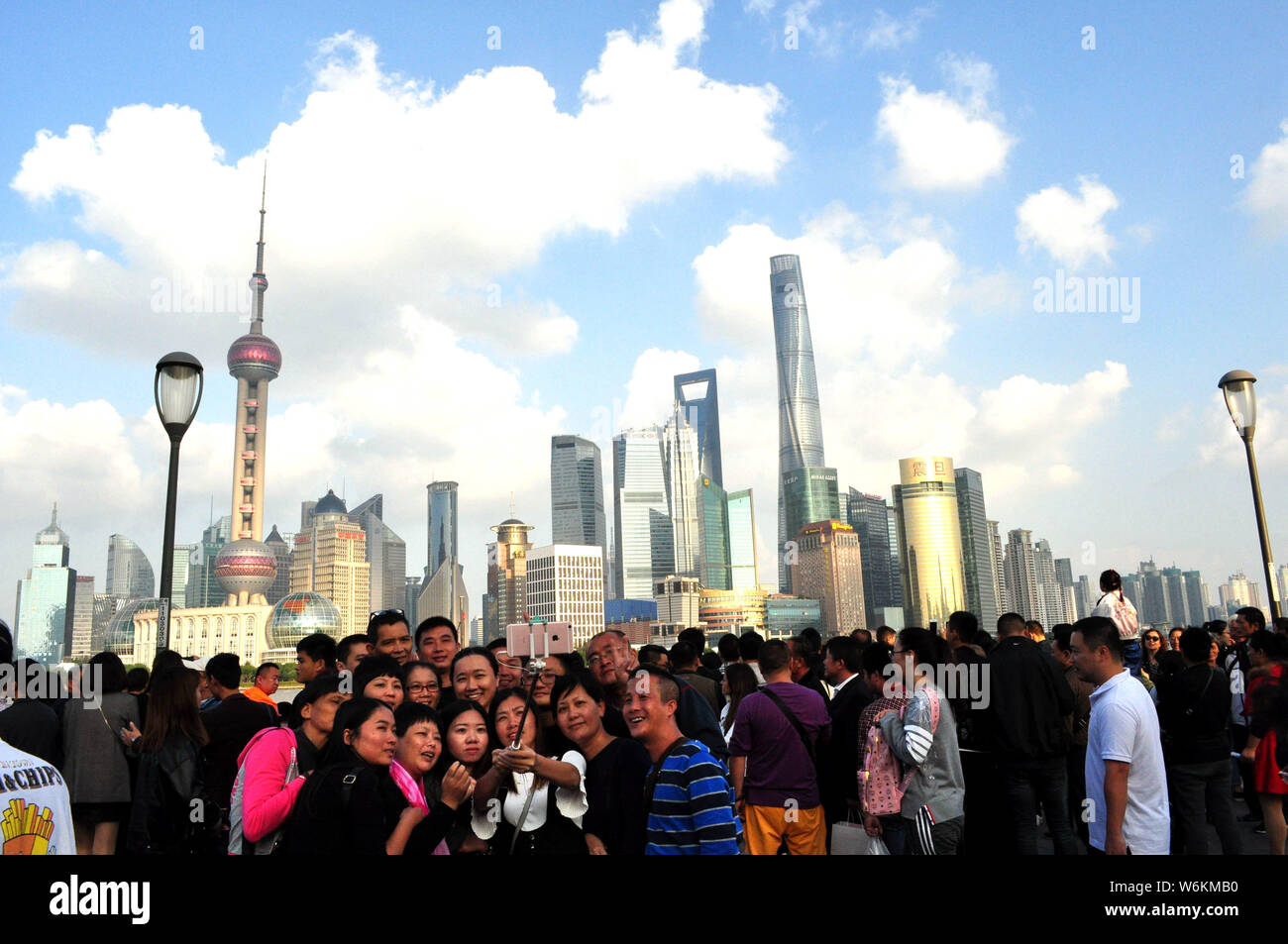 --FILE--Tourists crowd the promenade on the Bund along the Huangpu ...