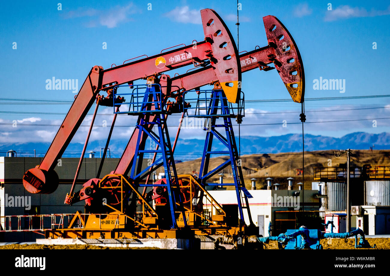 Derricks pump crude oil at an oil field of CNPC (China National ...