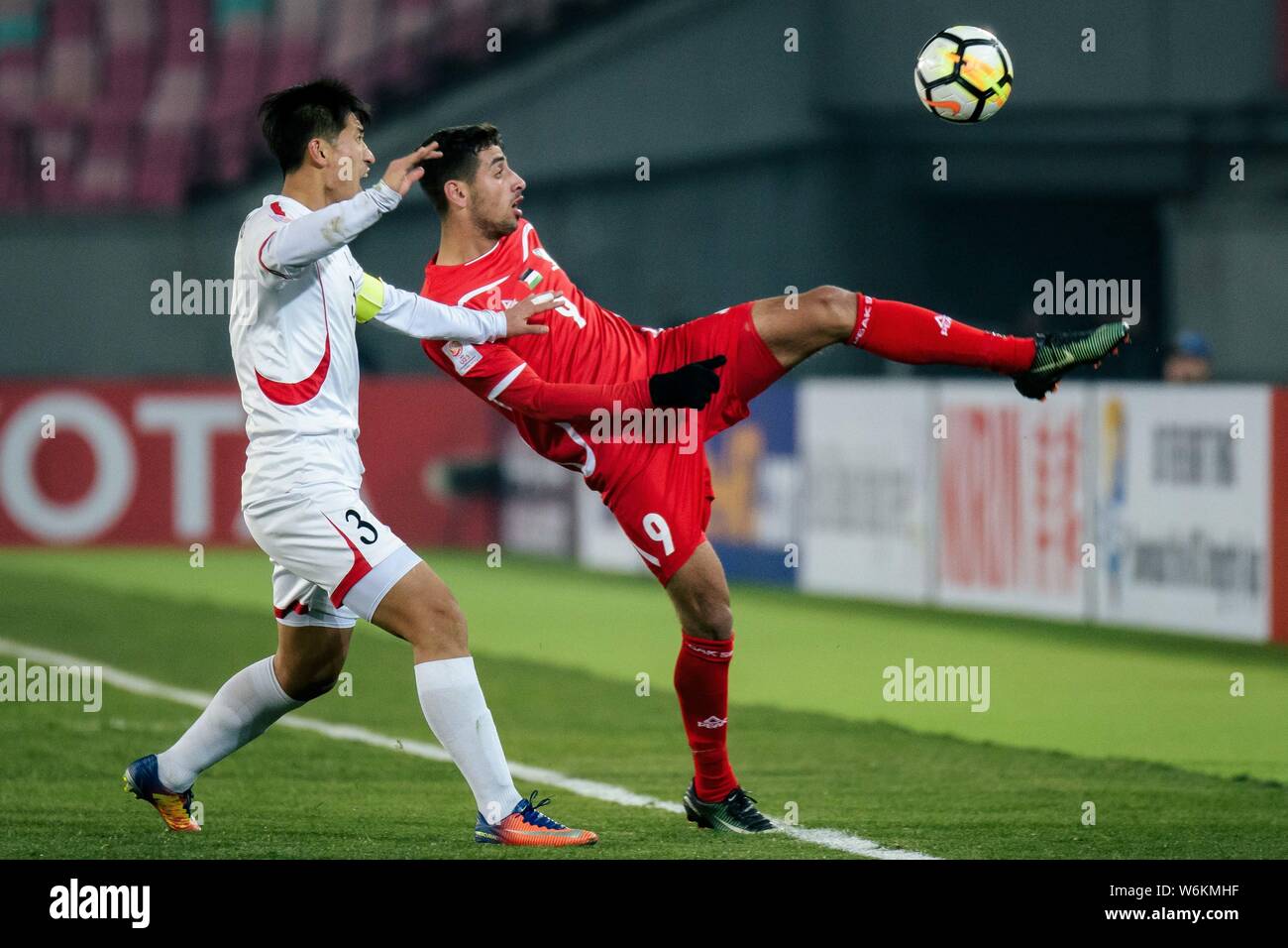 Oday Ibrahim Mohammad Dabbagh of Palestine, right, kicks the ball to ...
