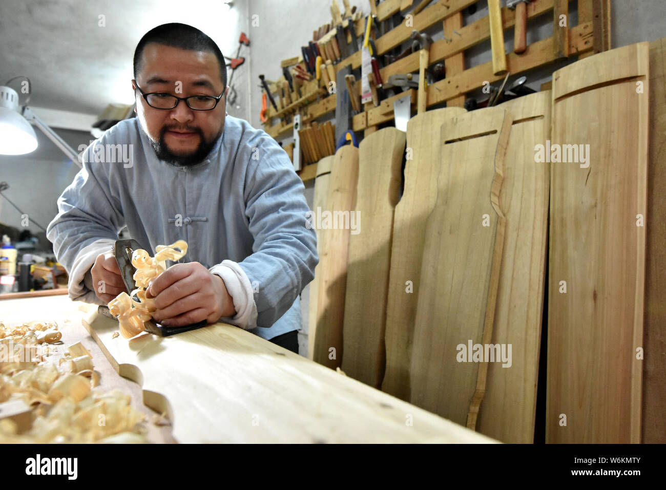 42-year-old Chinese craftsman Wang Bing processes a piece of wood for ...