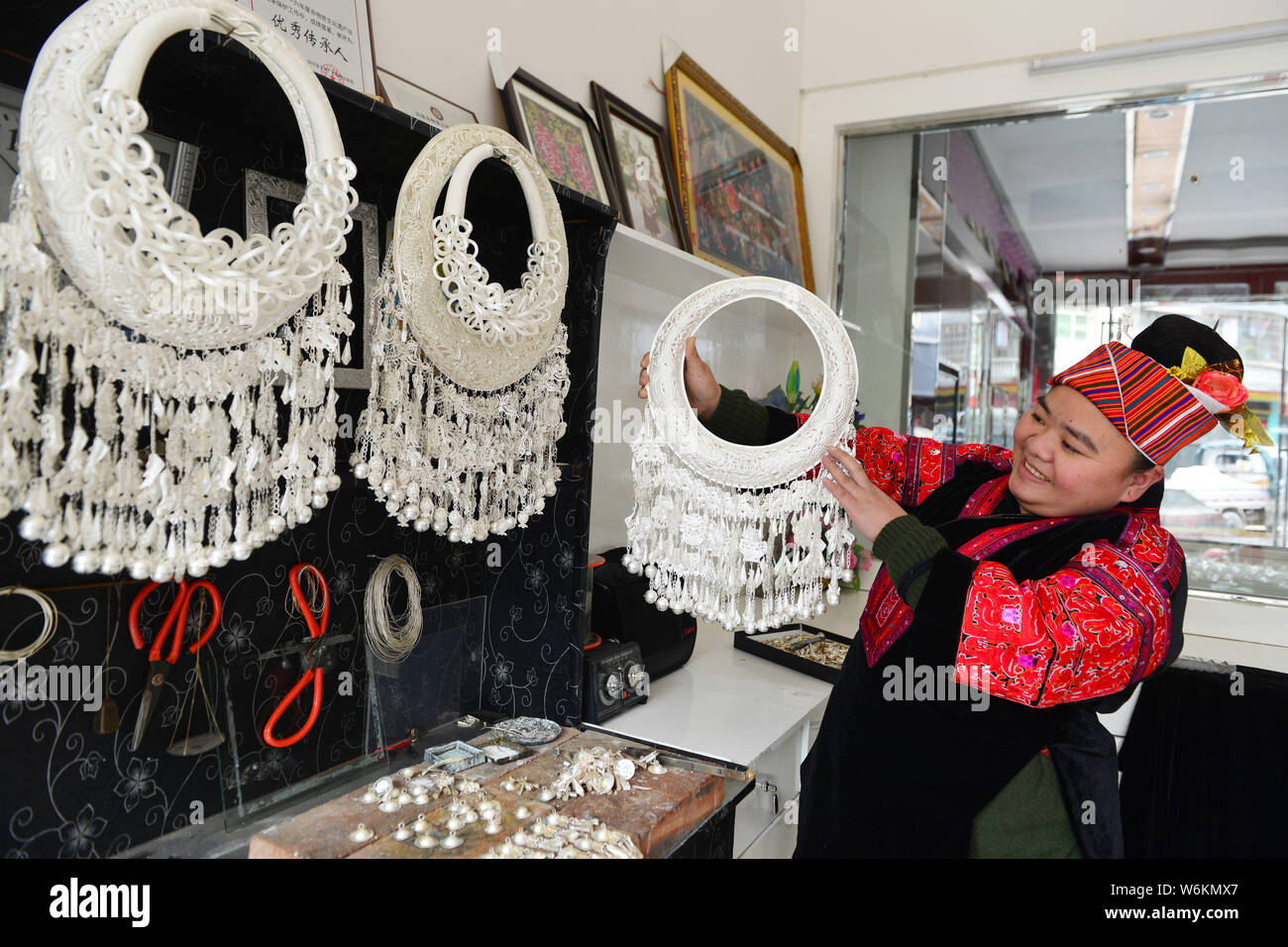 A Chinese craftsman shows a traditional silver decoration of Chinese ...