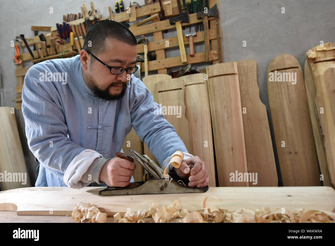 42-year-old Chinese craftsman Wang Bing processes a piece of wood for ...