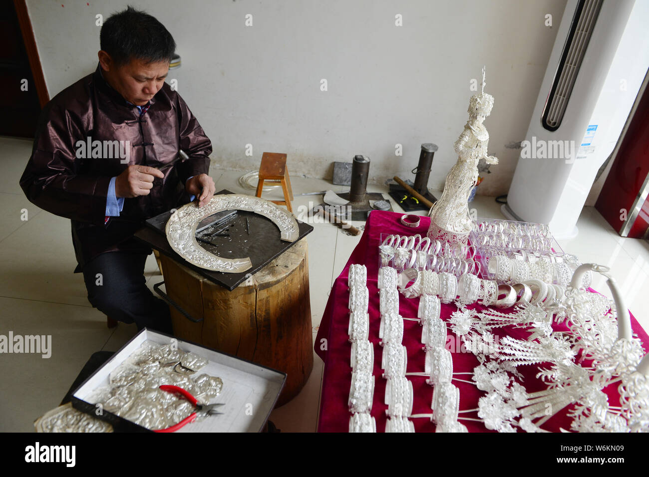 A Chinese craftsman makes traditional silver decorations of Chinese ...