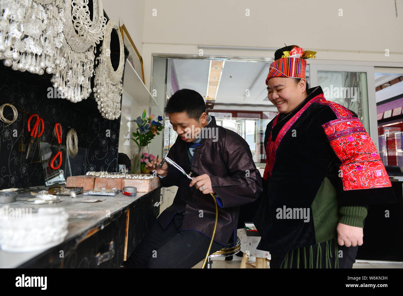 Chinese craftsmen make traditional silver decorations of Chinese ethnic ...