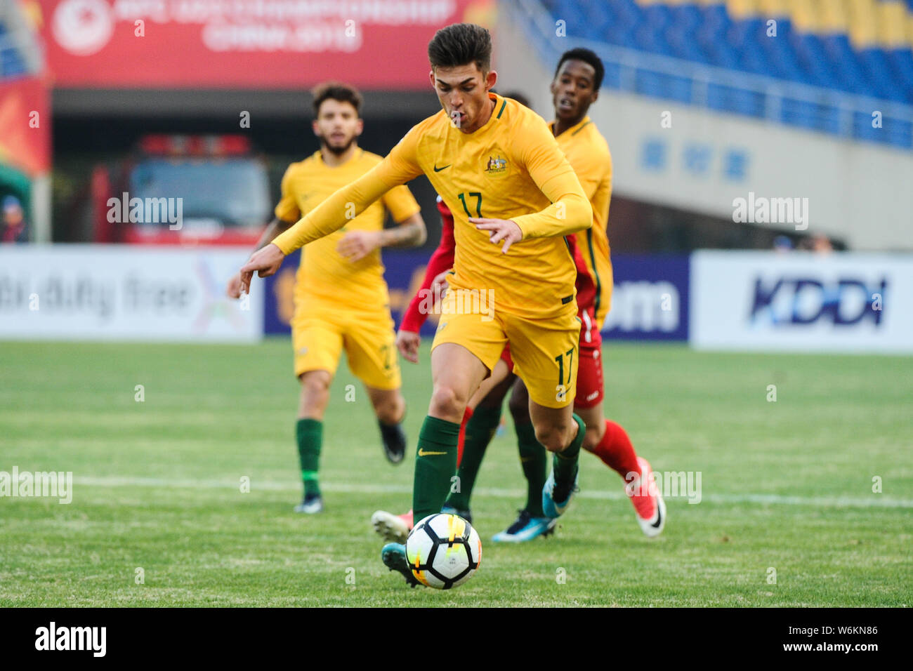 Brandon James Wilson, front, of Australia kicks the ball to make a pass ...
