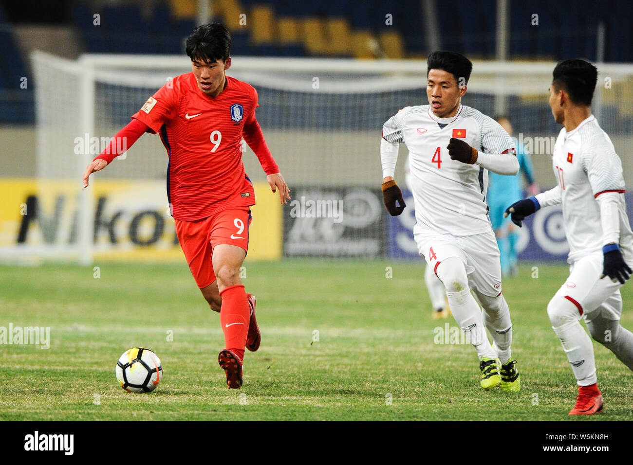 Lee Keun Ho, left, of South Korea kicks the ball to make a pass against Bui Tien Dung of Vietnam ...