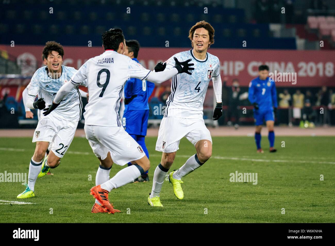 Players of Japan celebrate after scoring against Thailand in their Group B match during the 2018 ...