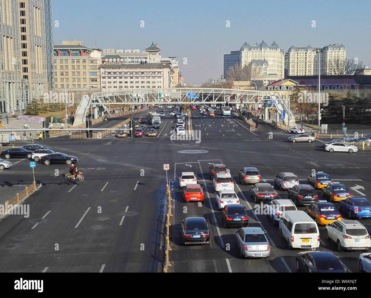 Vehicles drive under the newly-renovated Dongdan intersection, which is ...