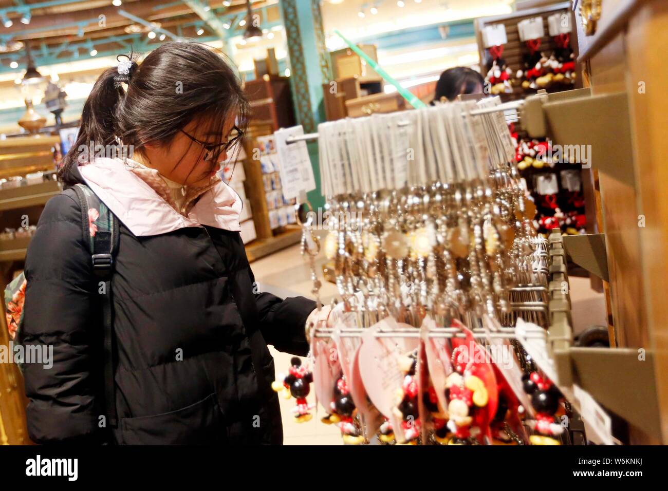 A Chinese girl shops for souvenirs in the theme of Chinese Lunar New ...